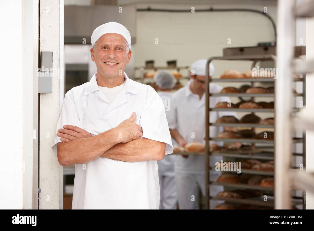 Chef smiling in kitchen Stock Photo - Alamy