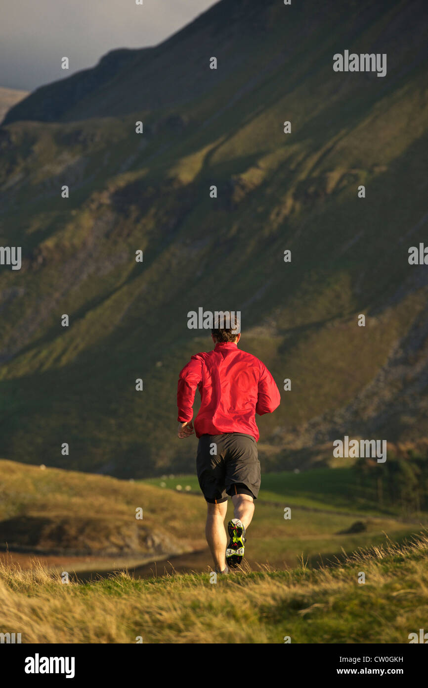 Man running on rural mountain road Stock Photo - Alamy