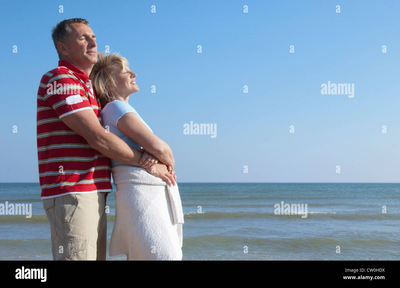 Older couple hugging on beach Stock Photo - Alamy