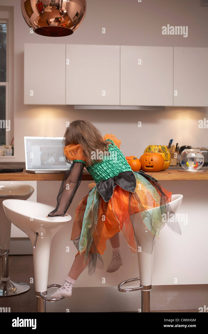 Girl in Halloween costume in kitchen Stock Photo - Alamy