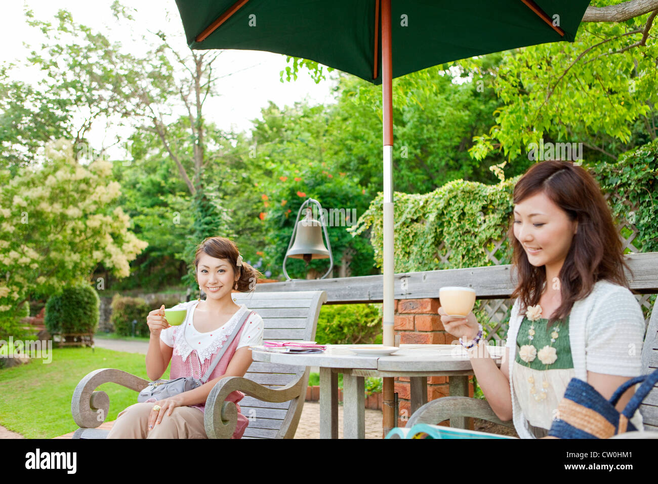 Two young women having tea Stock Photo - Alamy