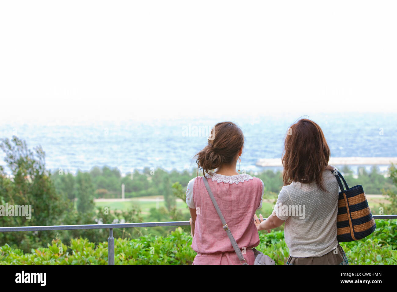 Two young women looking the sea Stock Photo - Alamy