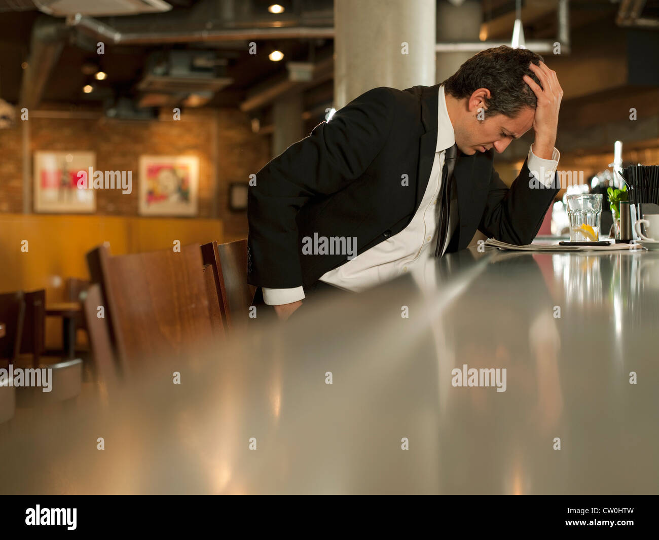 Businessman reading newspaper in cafe Stock Photo - Alamy