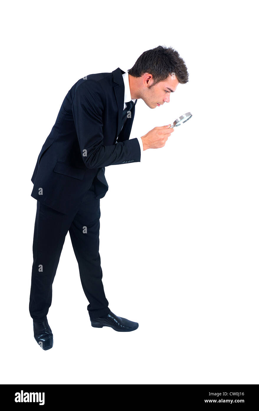 Isolated young business man with magnifying glass Stock Photo - Alamy