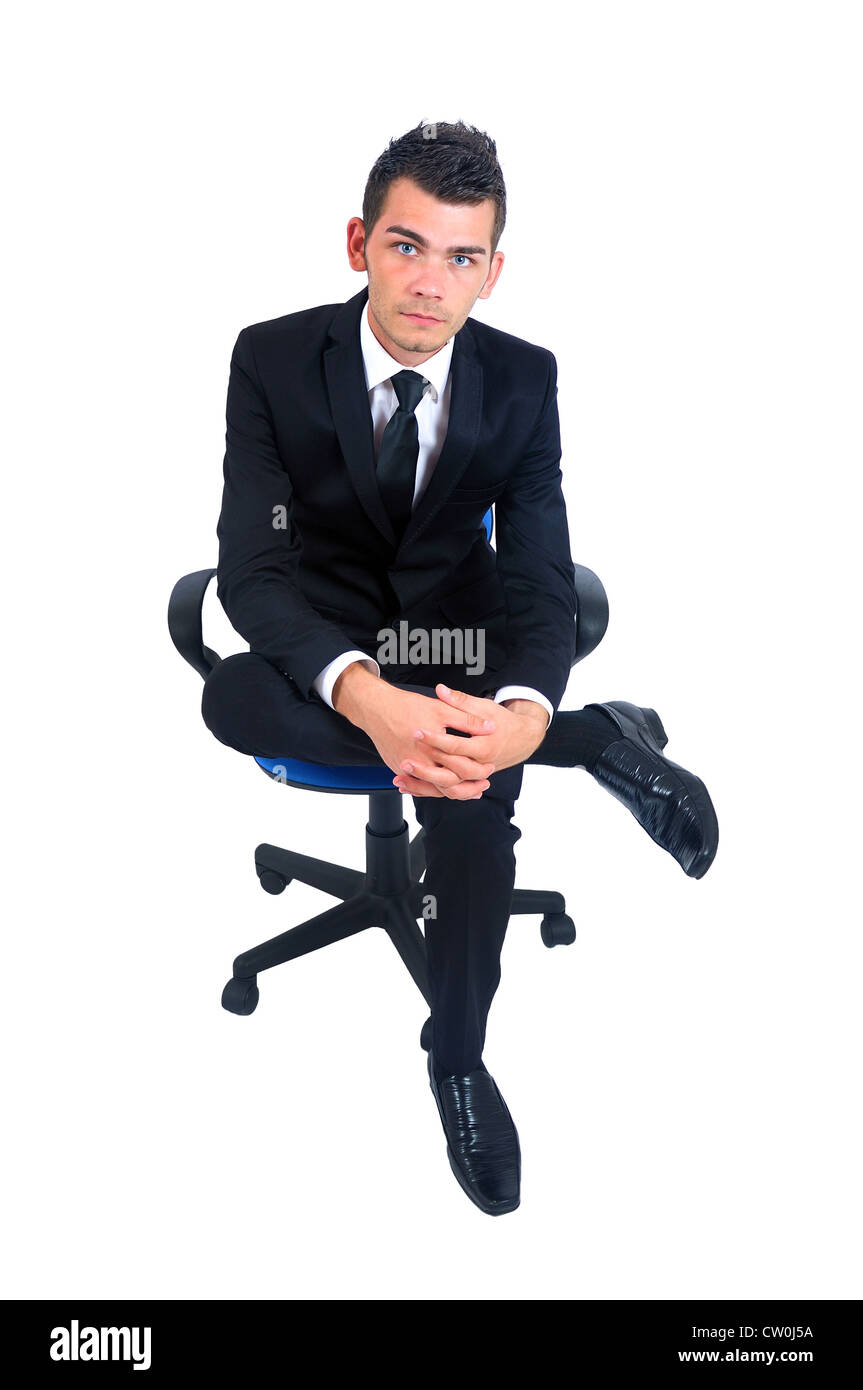 Isolated young business man standing on chair Stock Photo - Alamy