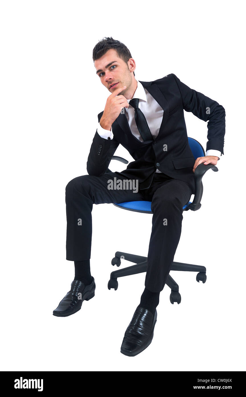 Isolated young business man standing on chair Stock Photo - Alamy