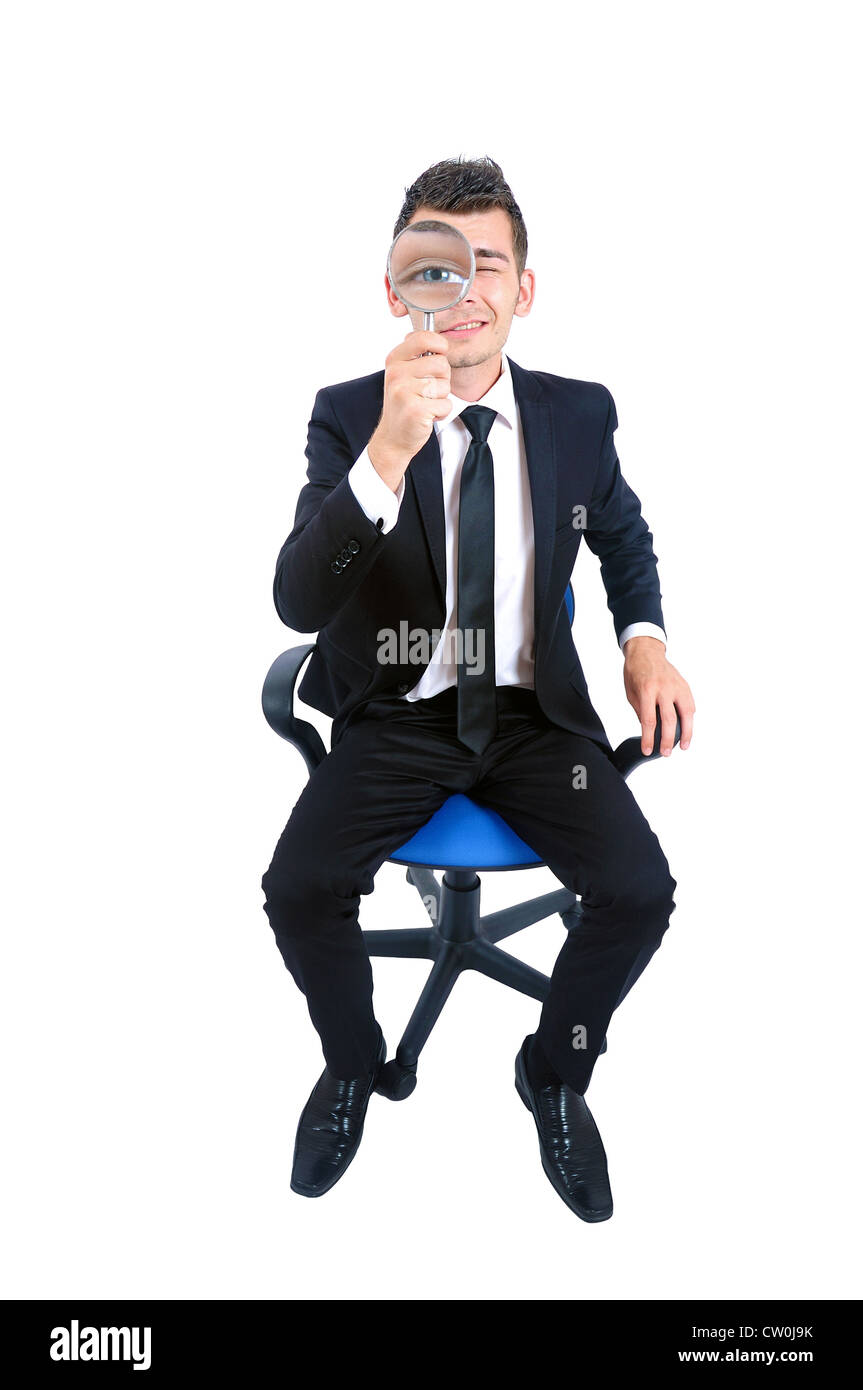 Isolated young business man with magnifying glass Stock Photo - Alamy