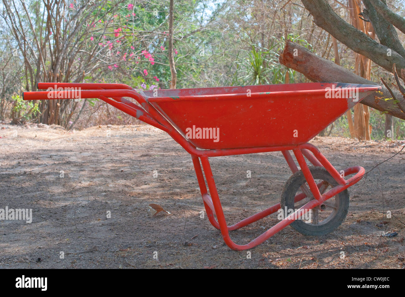 single wheel construction orange pushcart Stock Photo - Alamy