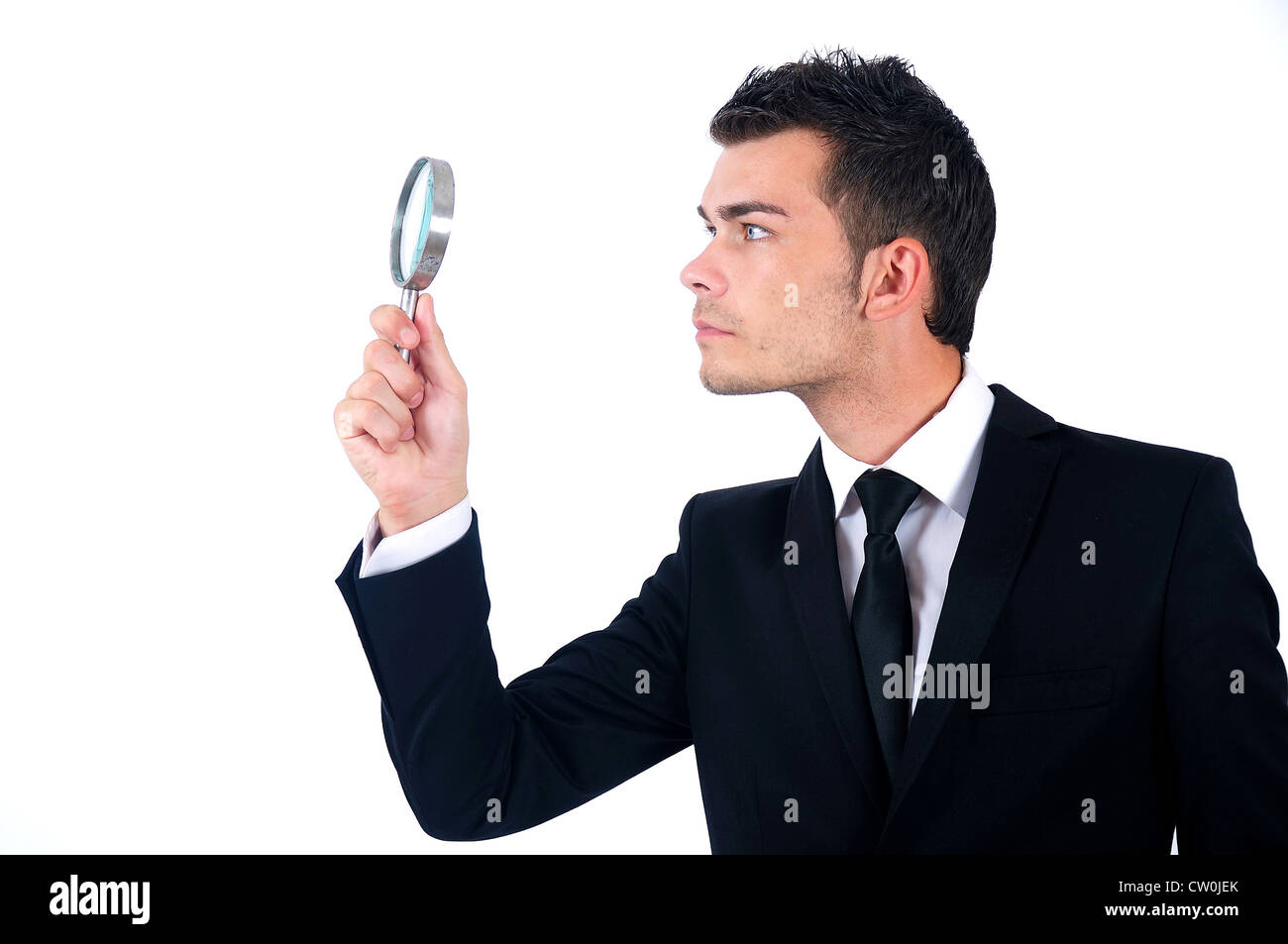 Isolated young business man with magnifying glass Stock Photo - Alamy