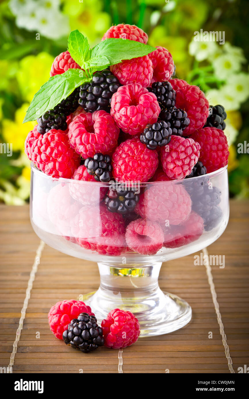 Sweet fresh fruits in glass goblet with mint leaf Stock Photo - Alamy