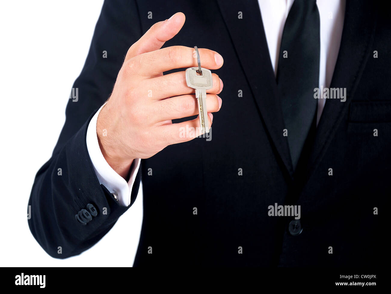 Isolated young business man giving key Stock Photo - Alamy