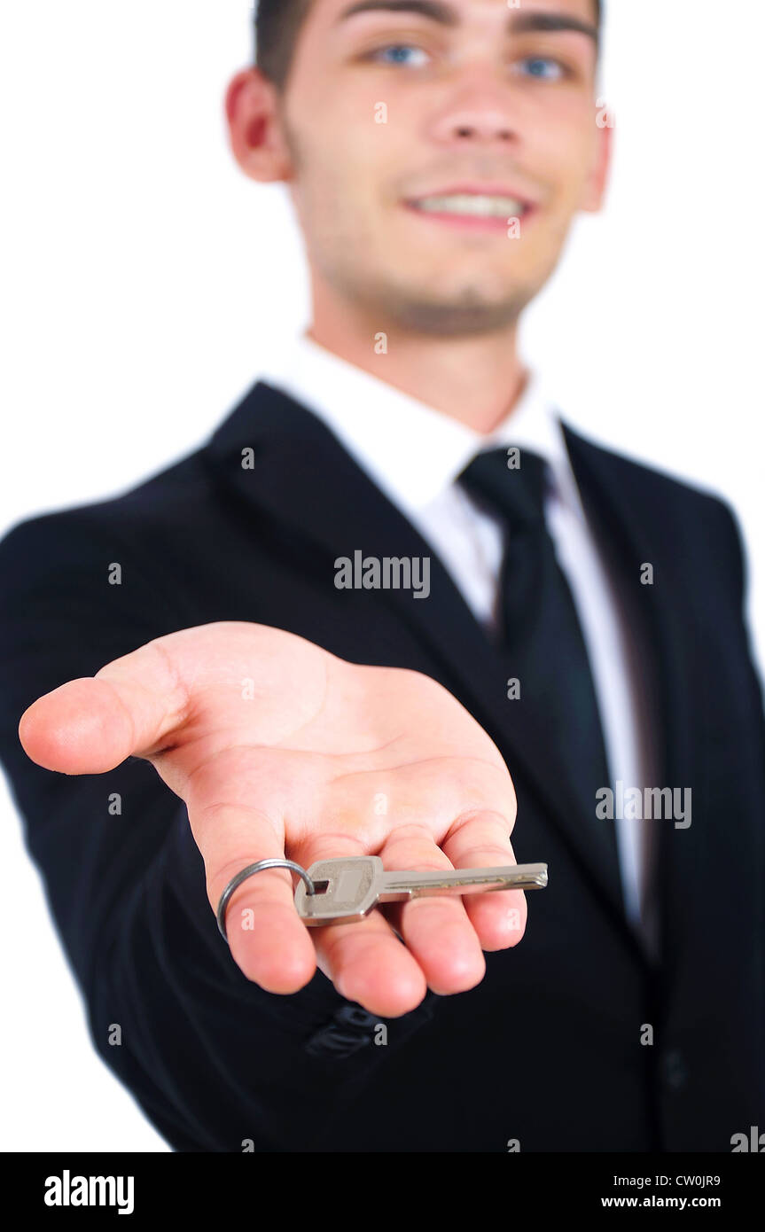 Isolated young business man giving key Stock Photo - Alamy