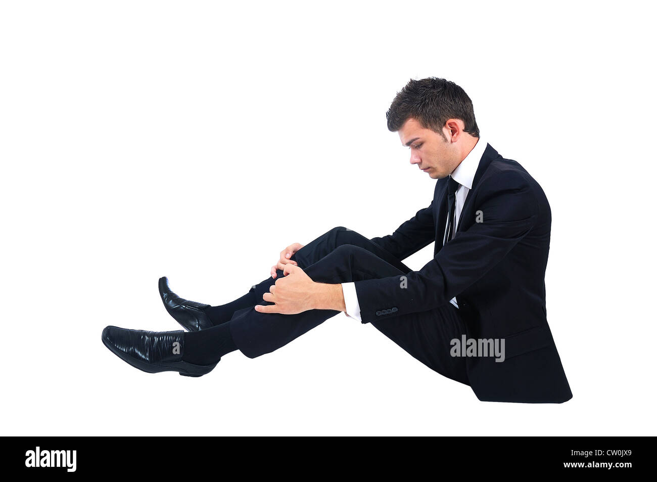 Isolated sad business man sitting down Stock Photo - Alamy