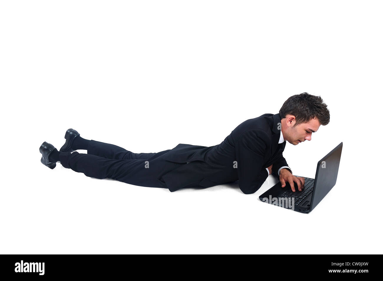 Isolated business man laying with notebook Stock Photo - Alamy