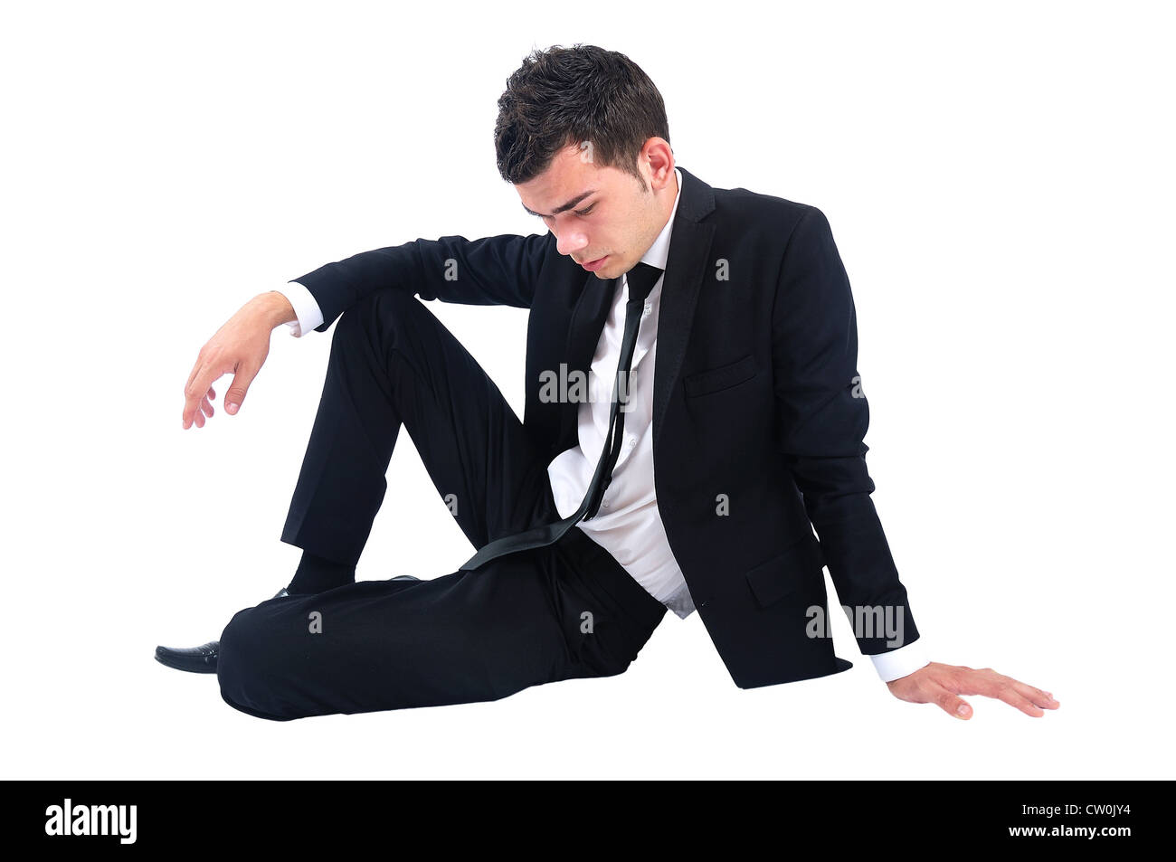Isolated sad business man sitting Stock Photo - Alamy