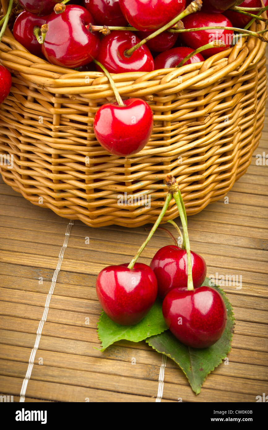Delicious sweet cherry fruits in wicker basket Stock Photo - Alamy