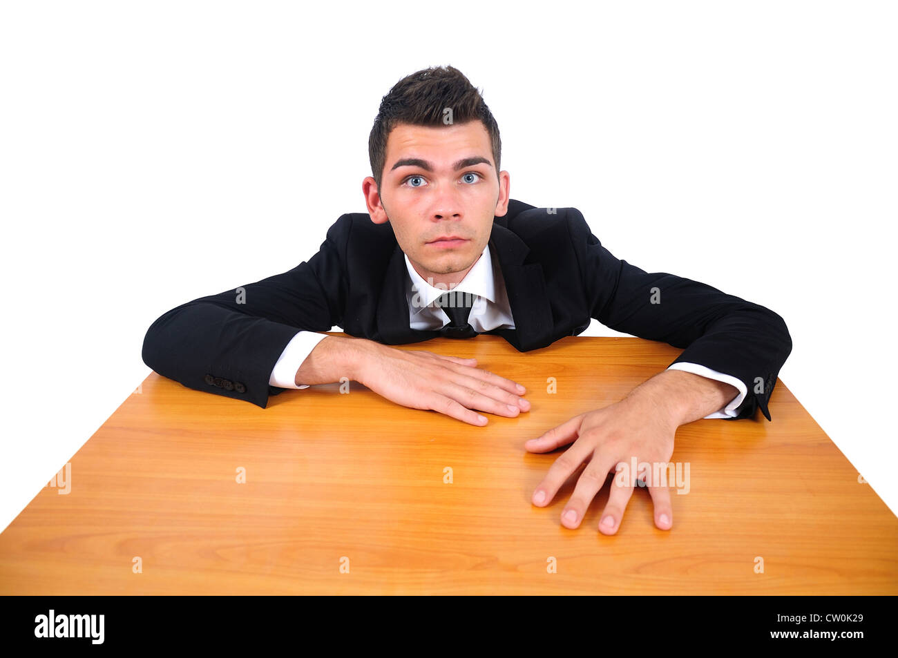 Isolated business man at confuse desk Stock Photo - Alamy