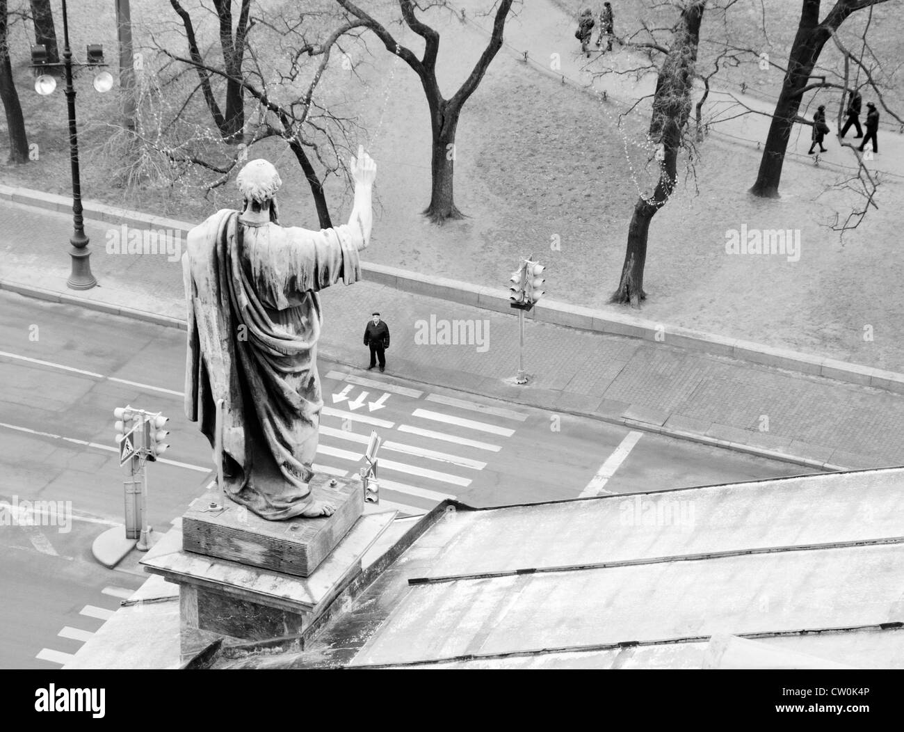 A man looking up at the statue on the roof of the Saint Isaac's ...