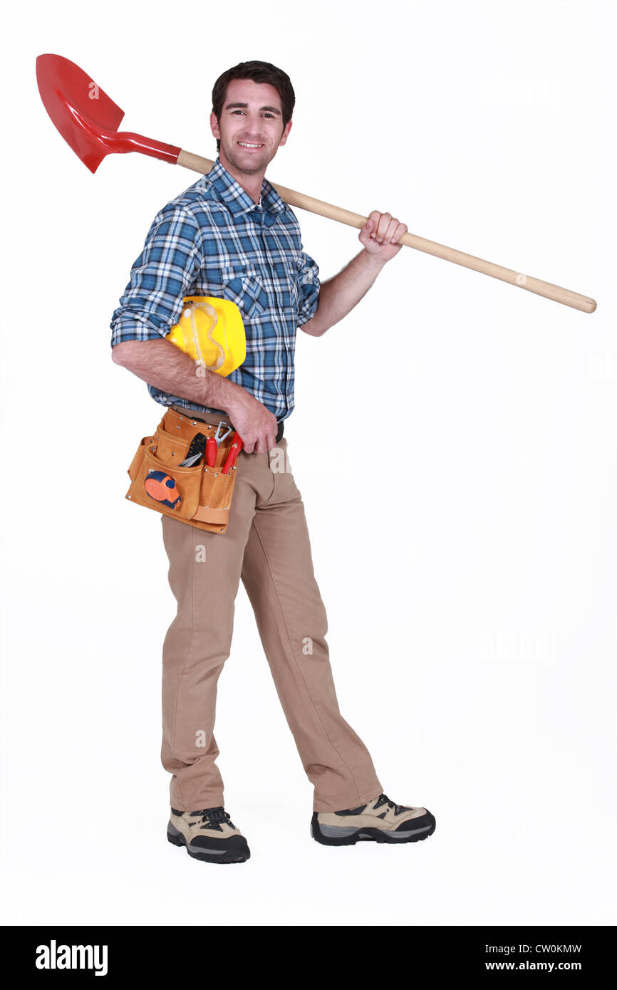 Manual worker holding shovel Stock Photo - Alamy