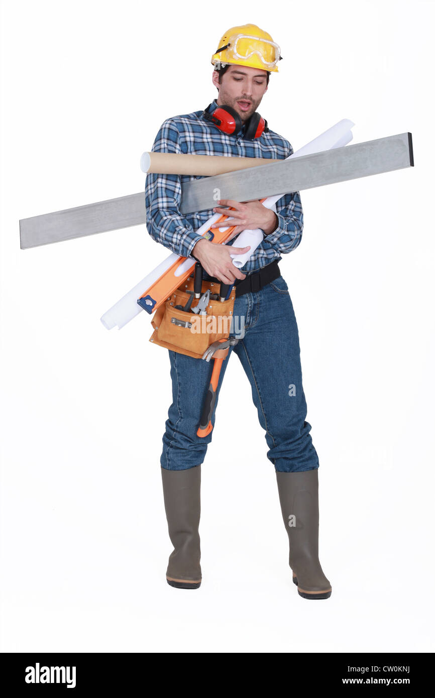 A construction worker with his arms loaded Stock Photo - Alamy