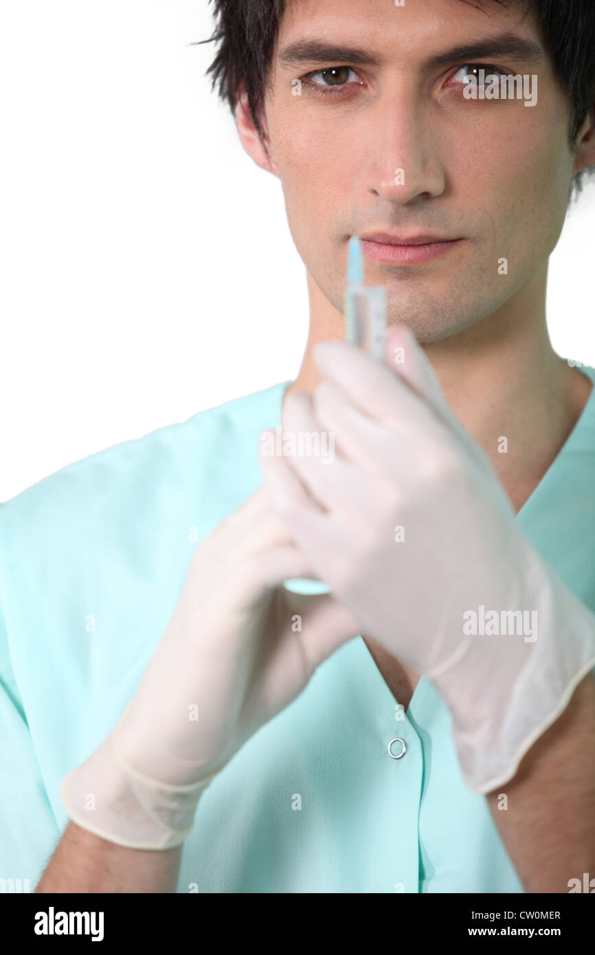 Nurse holding syringe Stock Photo - Alamy