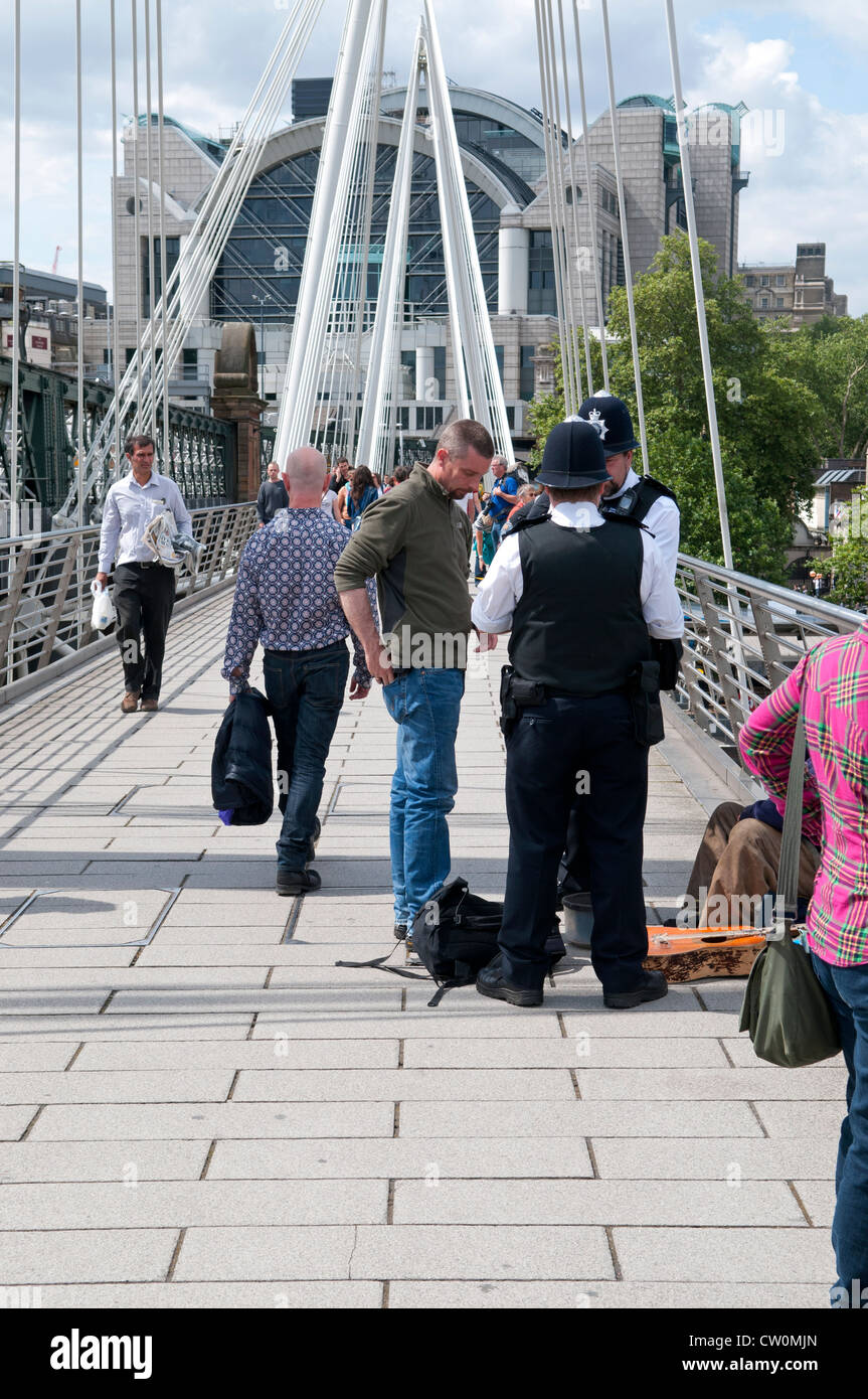 Police officers on Hungerford, Golden Jubilee bridge in London Stock ...