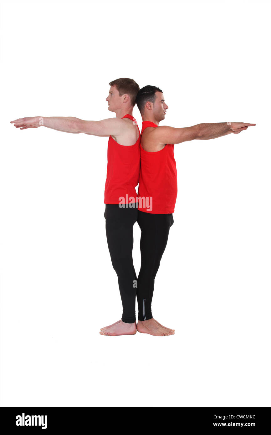 Male gymnasts back to back Stock Photo - Alamy