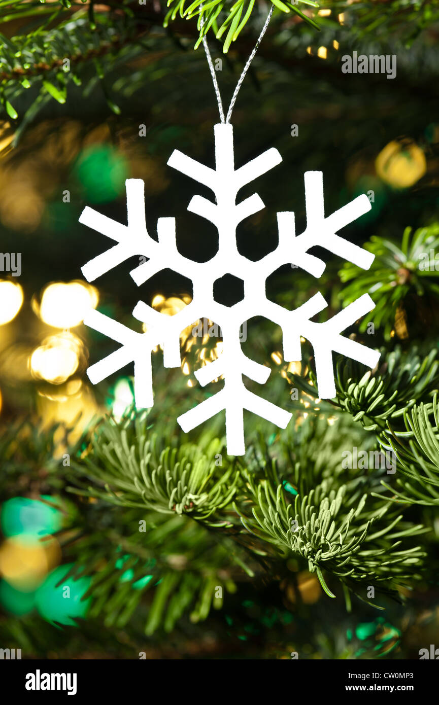 White artificial snowflake in Christmas tree Stock Photo - Alamy