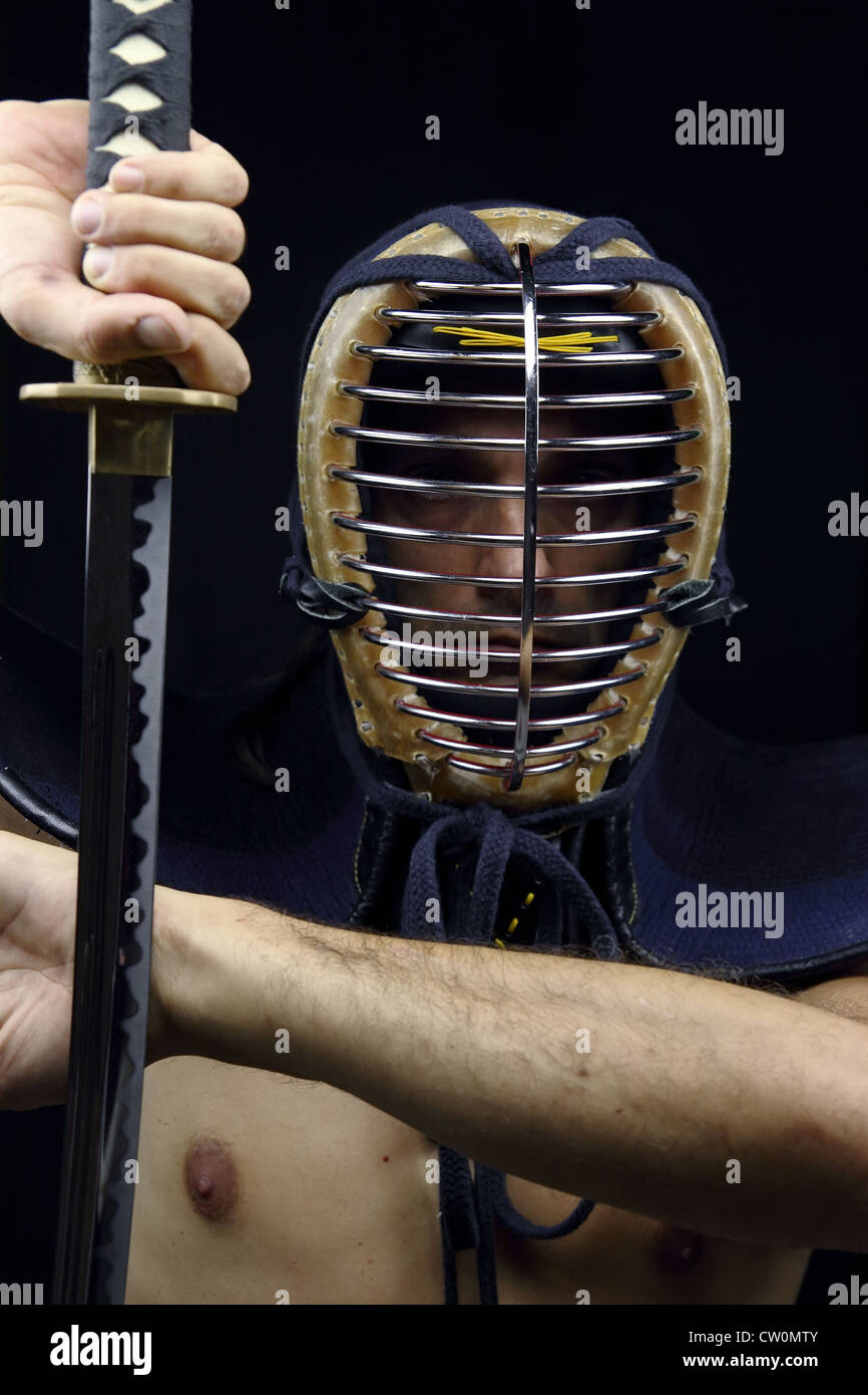 man holding samurai sword in dramatic studio light Stock Photo - Alamy