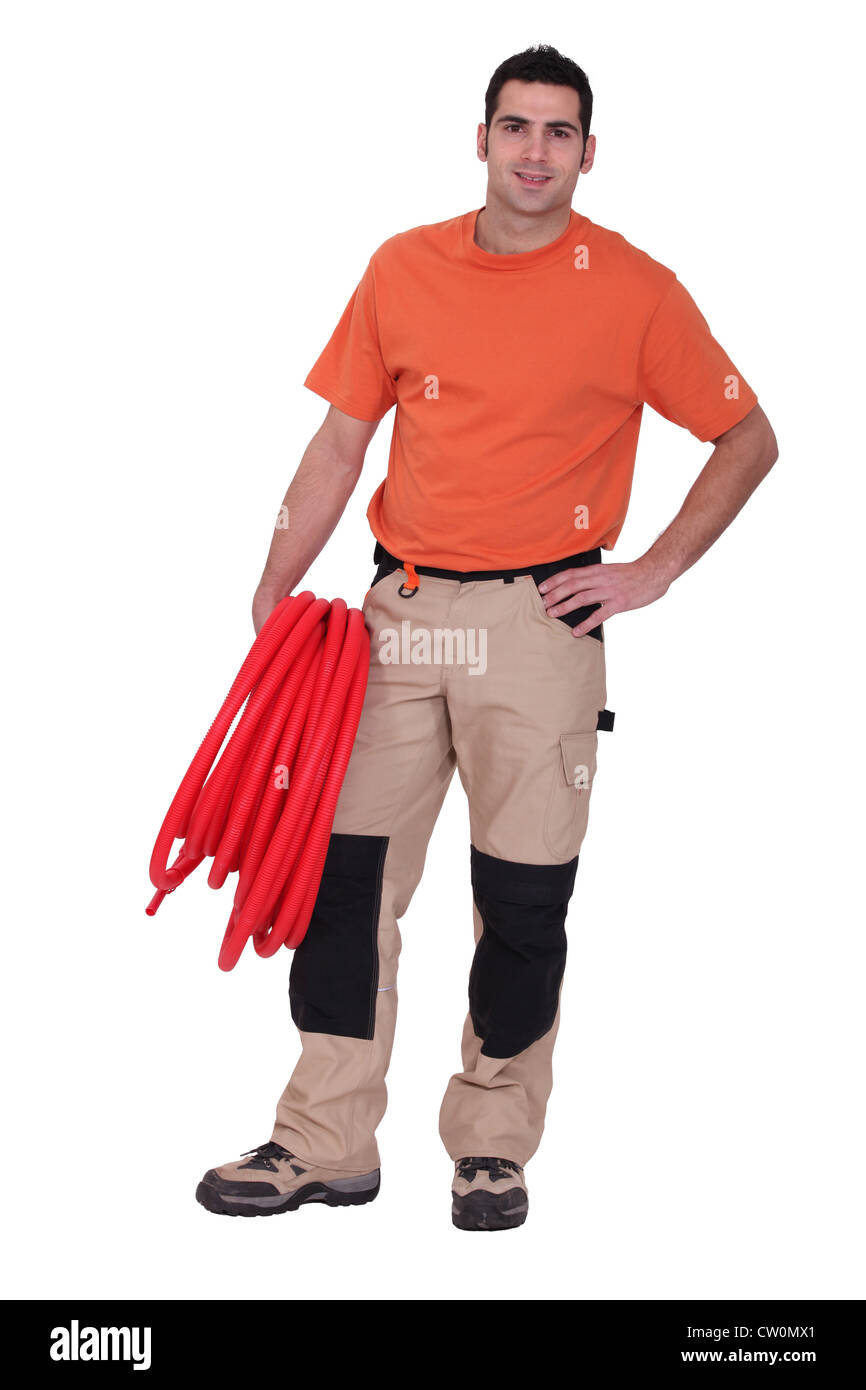 full-length shot of plumber carrying hose Stock Photo - Alamy