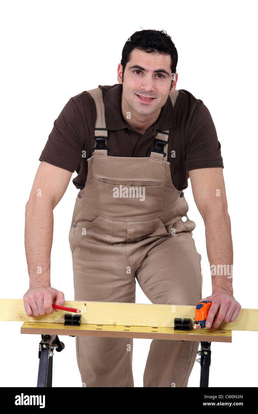 A carpenter taking measures Stock Photo - Alamy