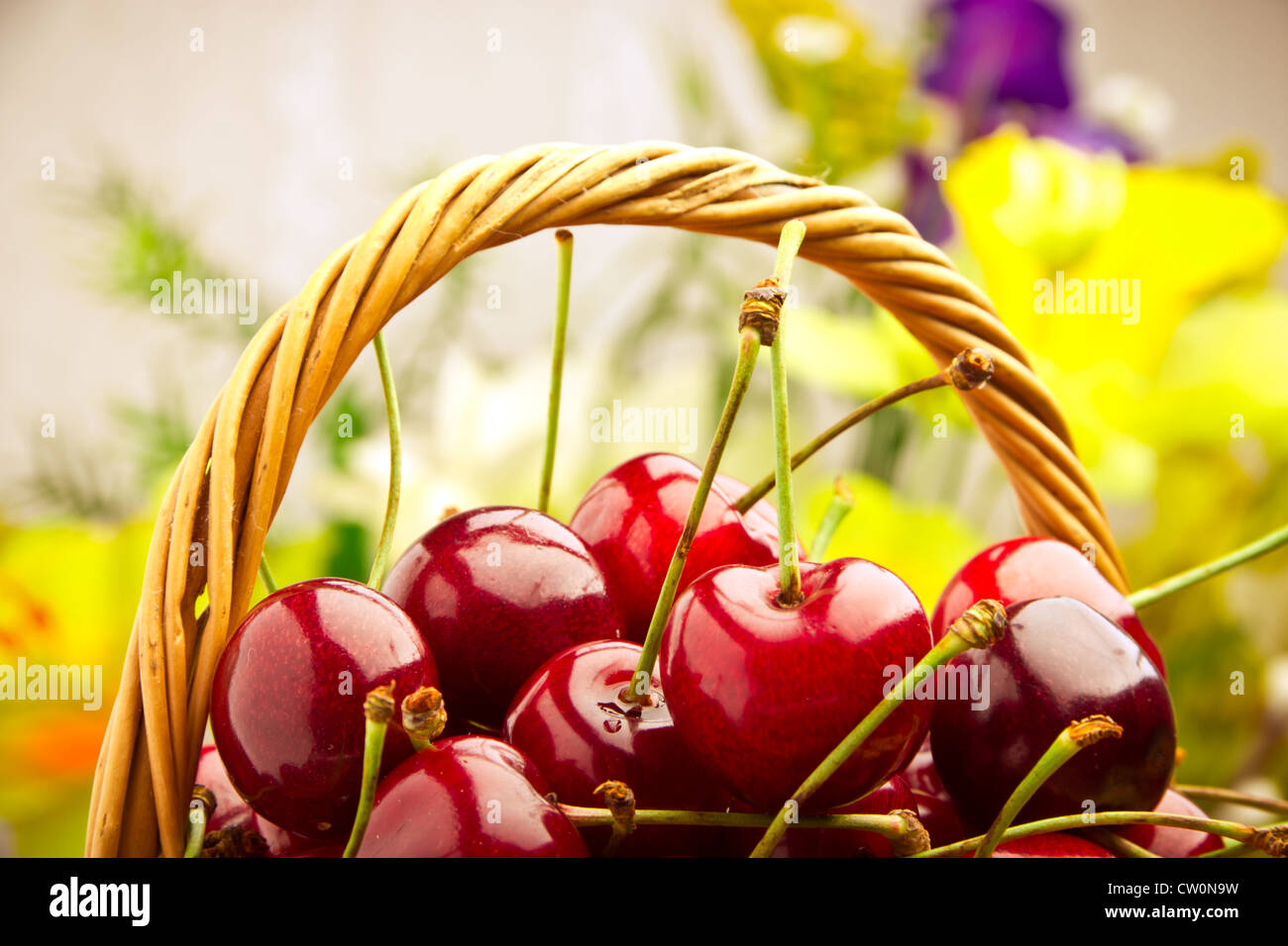 Delicious sweet cherry fruits in wicker basket Stock Photo - Alamy