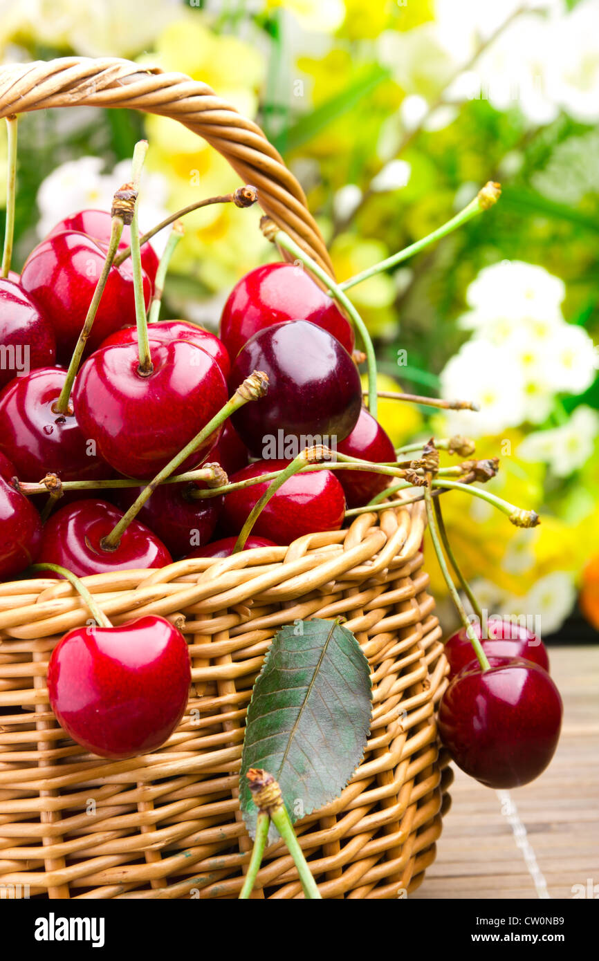 Delicious sweet cherry fruits in wicker basket Stock Photo - Alamy