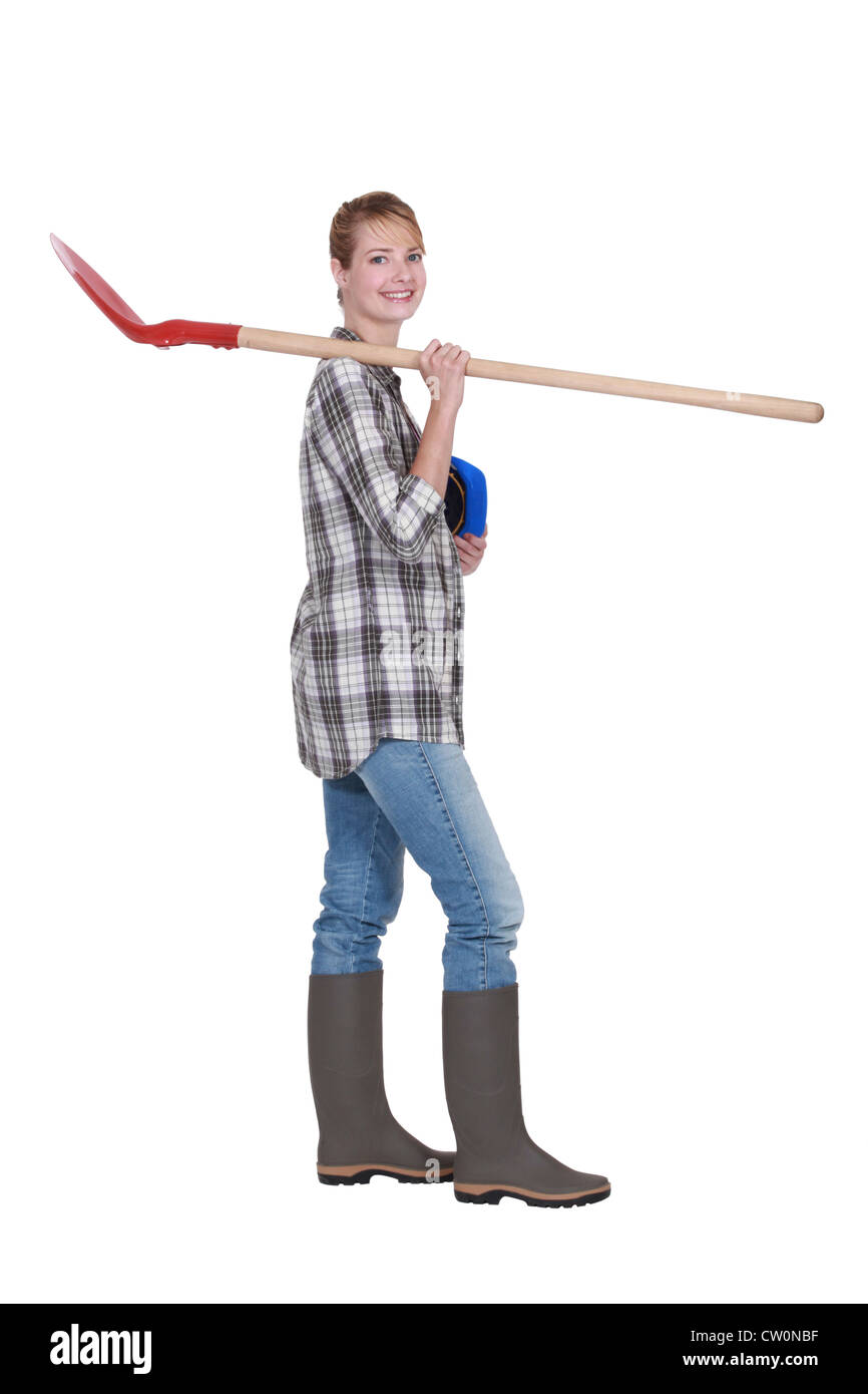 craftswoman holding a shovel on her shoulder Stock Photo - Alamy