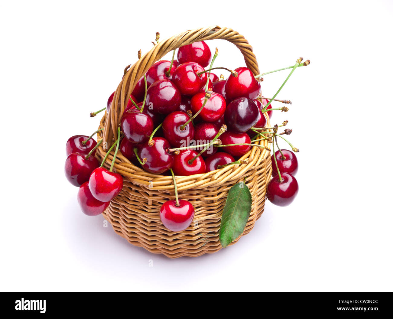 Delicious sweet cherry fruits in wicker basket Stock Photo - Alamy