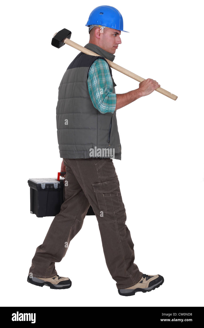 Construction worker carrying tools Stock Photo - Alamy