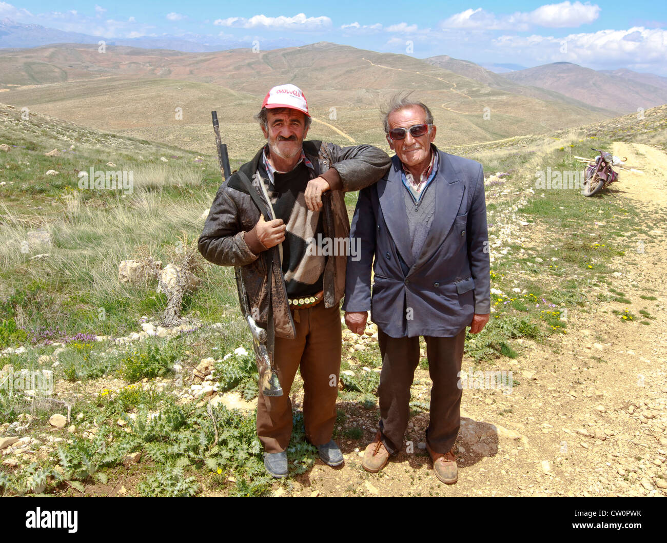 Mountain village hunter with his lift and rifle on the main road from ...