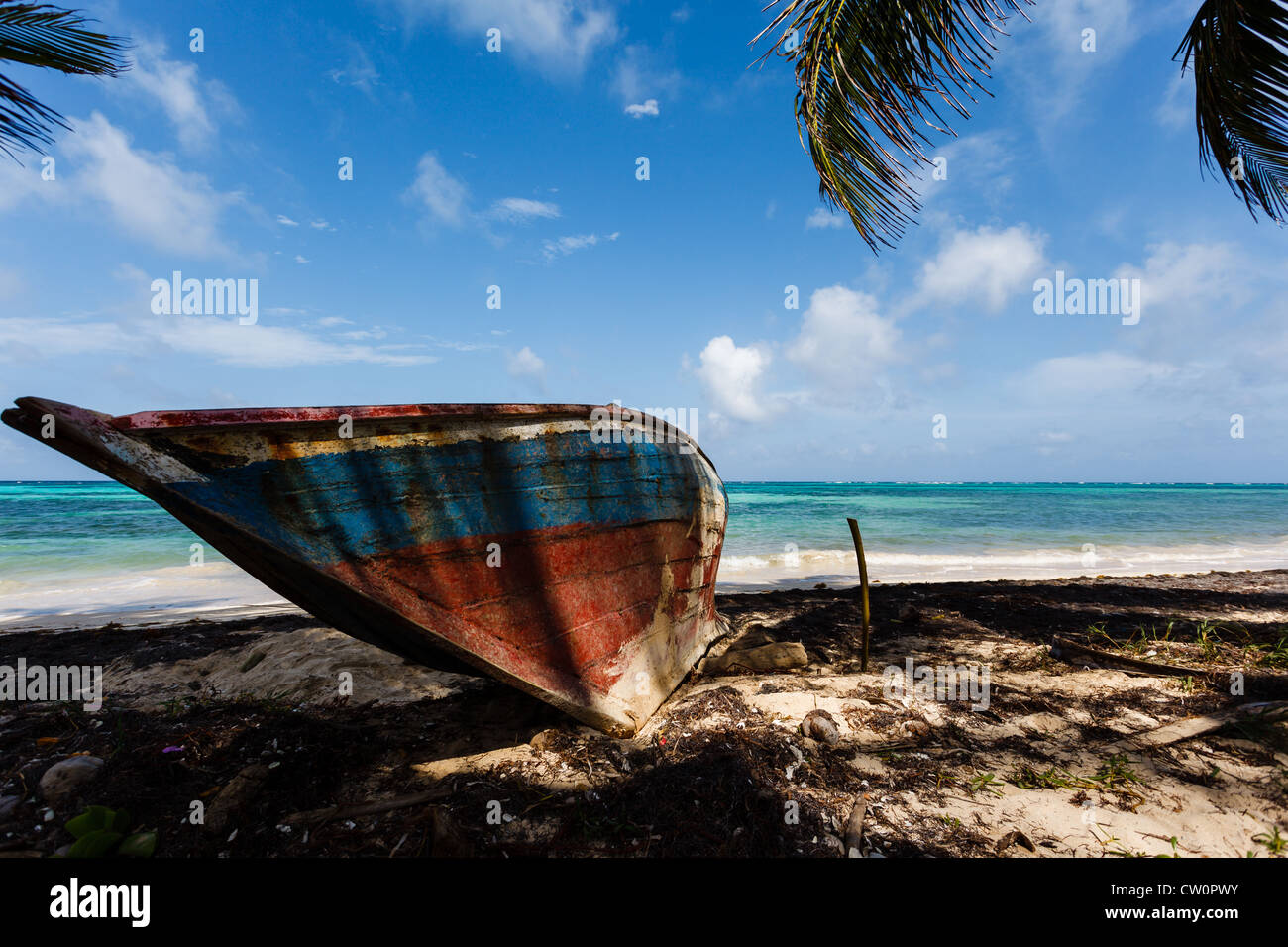 Colorful,wooden fishing boat washed up and marooned on a deserted ...