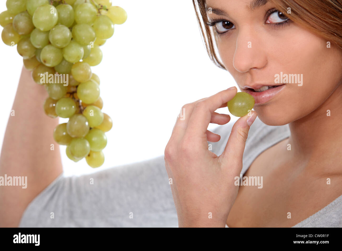Woman eating grapes Stock Photo - Alamy