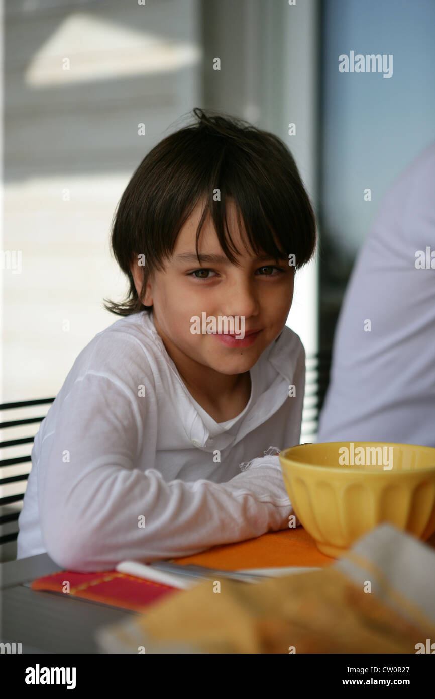 Young boy at the breakfast table Stock Photo - Alamy