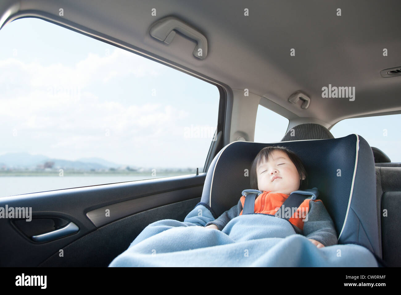 A boy sleeping in a car Stock Photo - Alamy