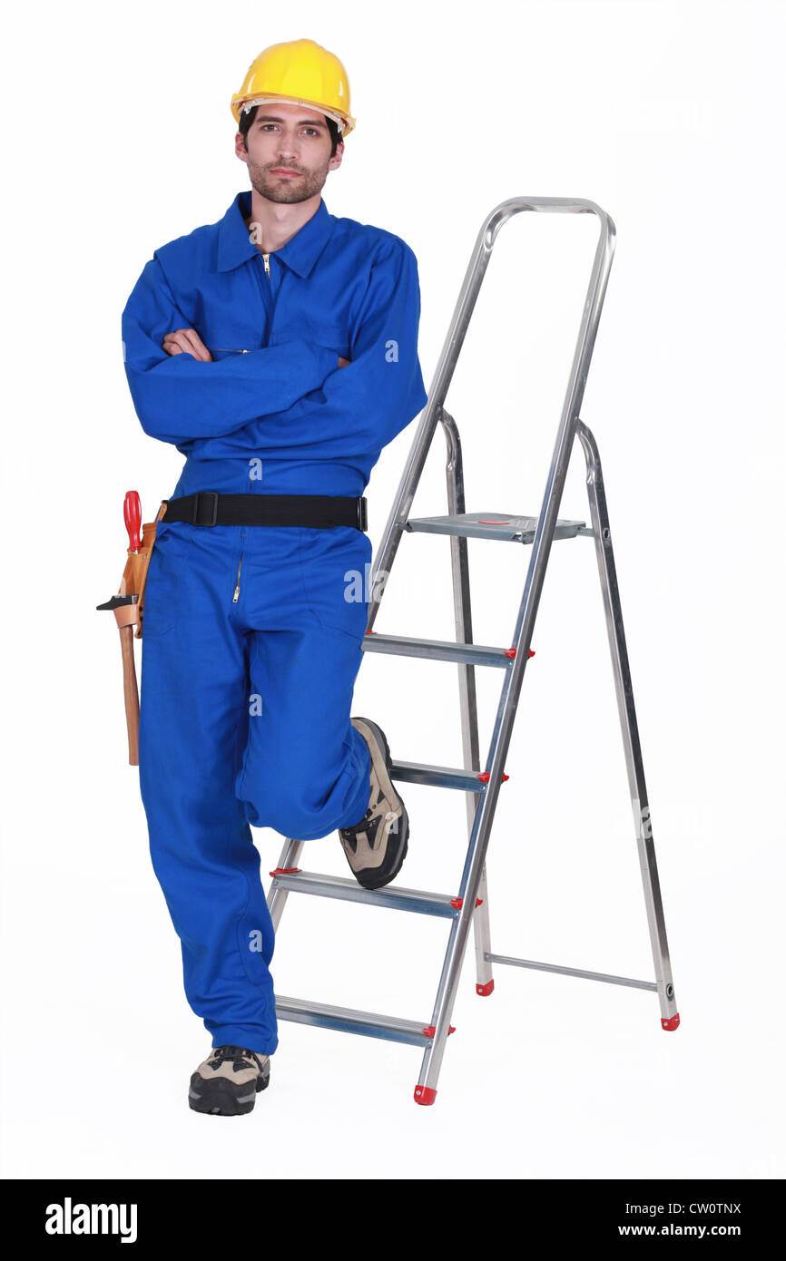 Laborer leaning on a ladder, studio shot Stock Photo - Alamy