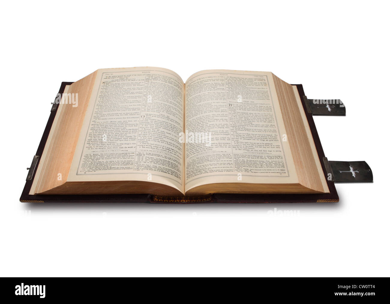A very ornate and large Holy Bible opened flat on a white background ...