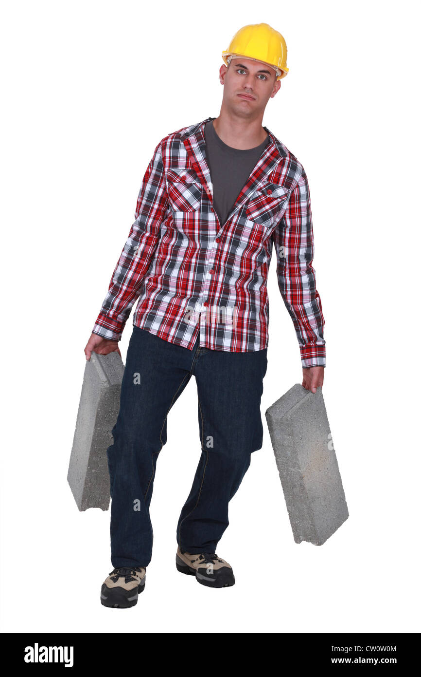 Mason carrying cinderblocks Stock Photo - Alamy