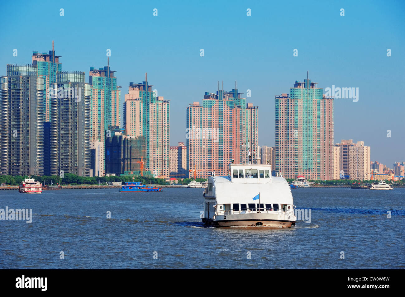 Shanghai skyline over river with boat Stock Photo - Alamy