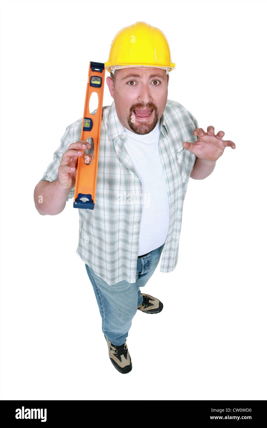 Scared builder with a spirit level Stock Photo - Alamy