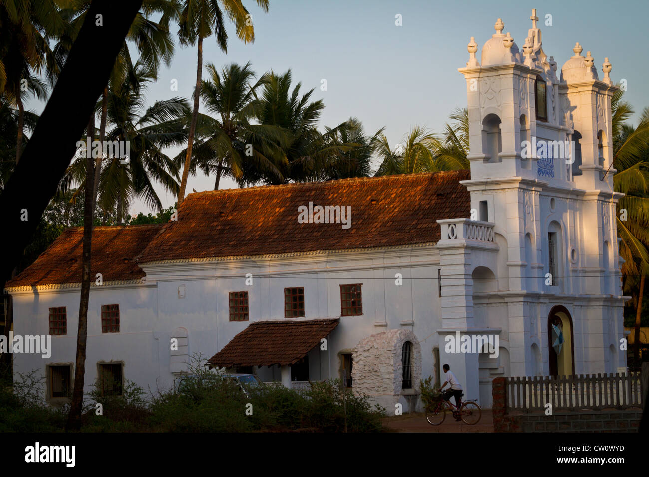 Man cycles past the christian church in Anjuna, Goa Stock Photo - Alamy