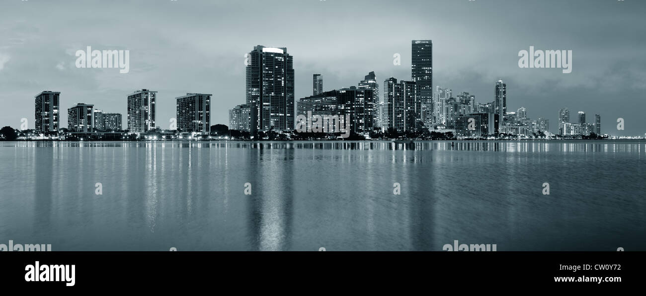 Miami city skyline panorama at dusk with urban skyscrapers over sea ...
