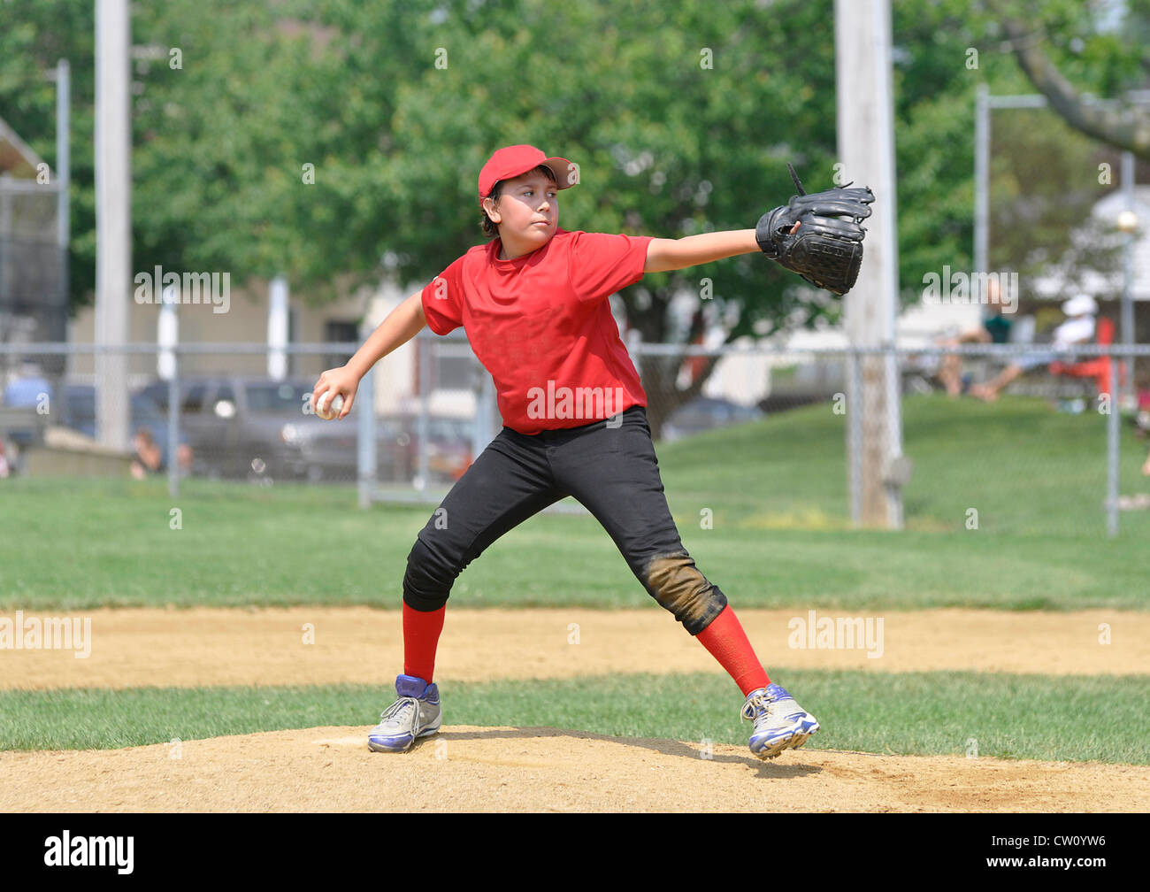 action shot of alittle league baseball pitcher on the pitcher's mound ...