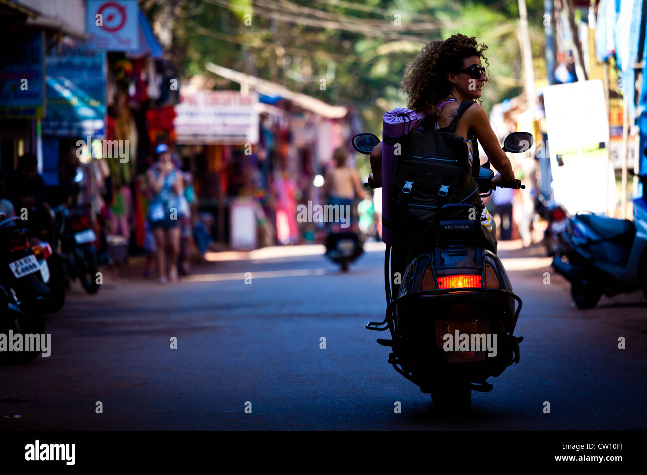 Tourist on a scooter in the main street by Mandrem Beach in Goa Stock ...